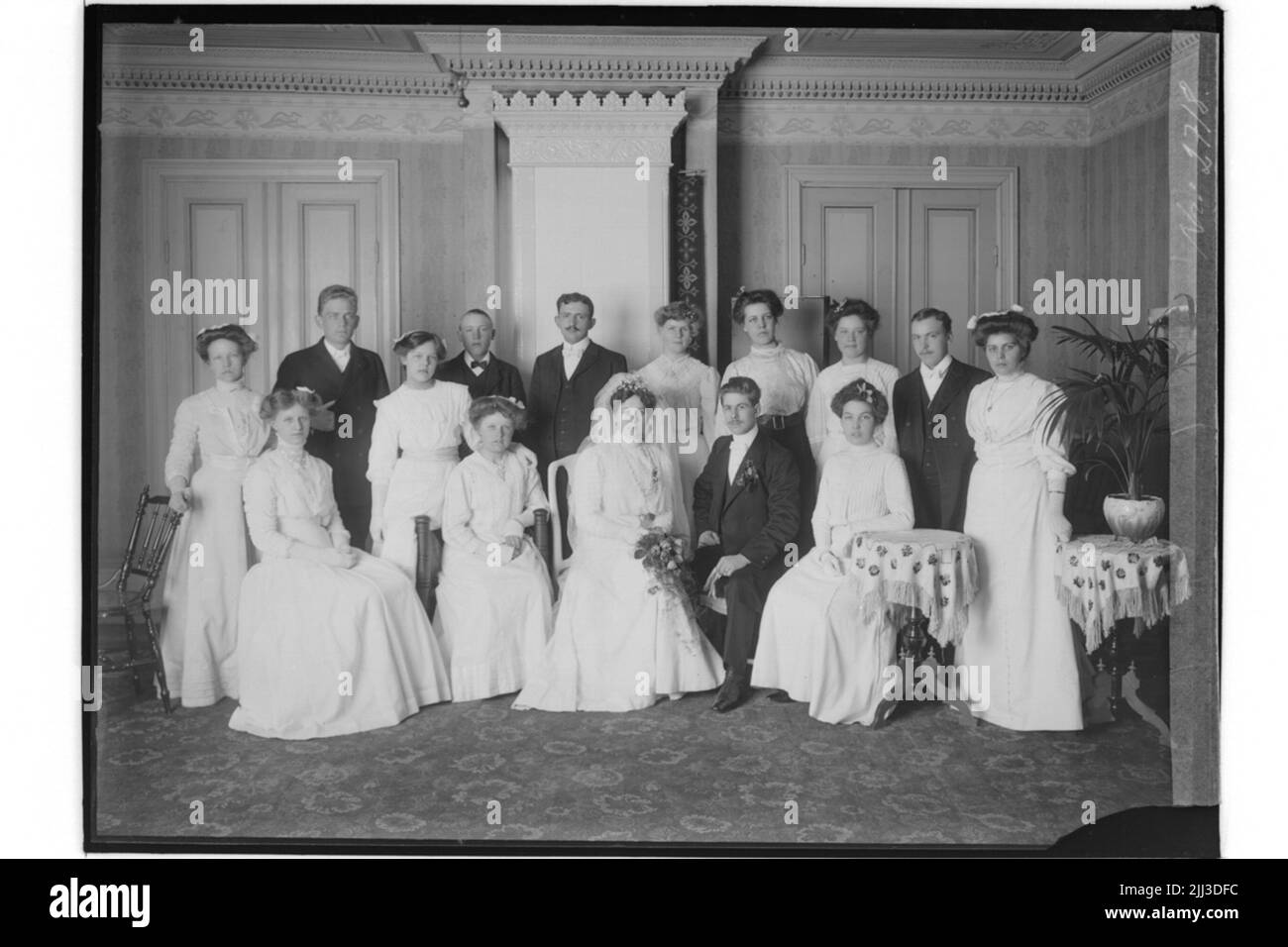 Room interior. Wedding. Bridal couple and 13 guests. The bride ...