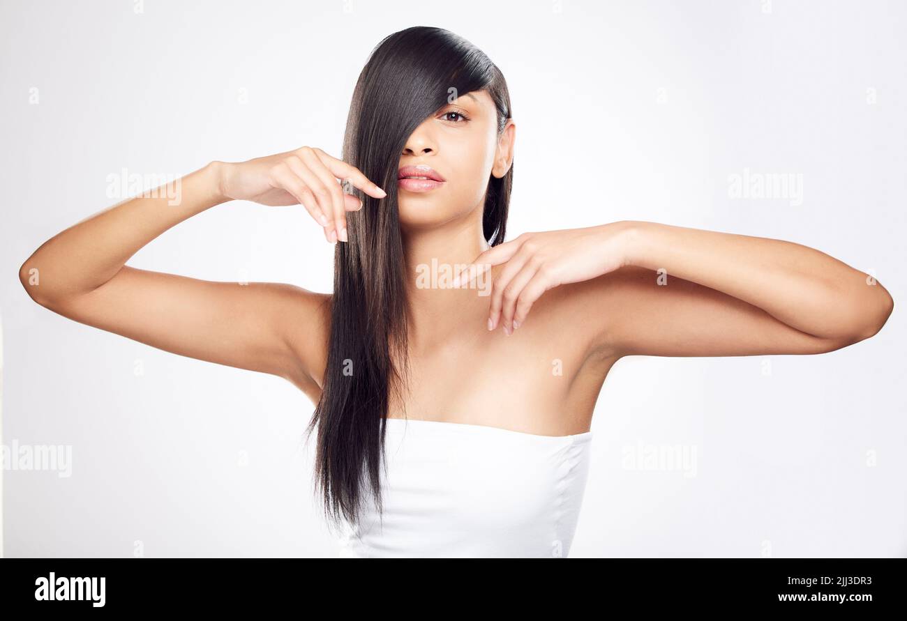 Be sleek not sly. a young woman posing against a white background with ...