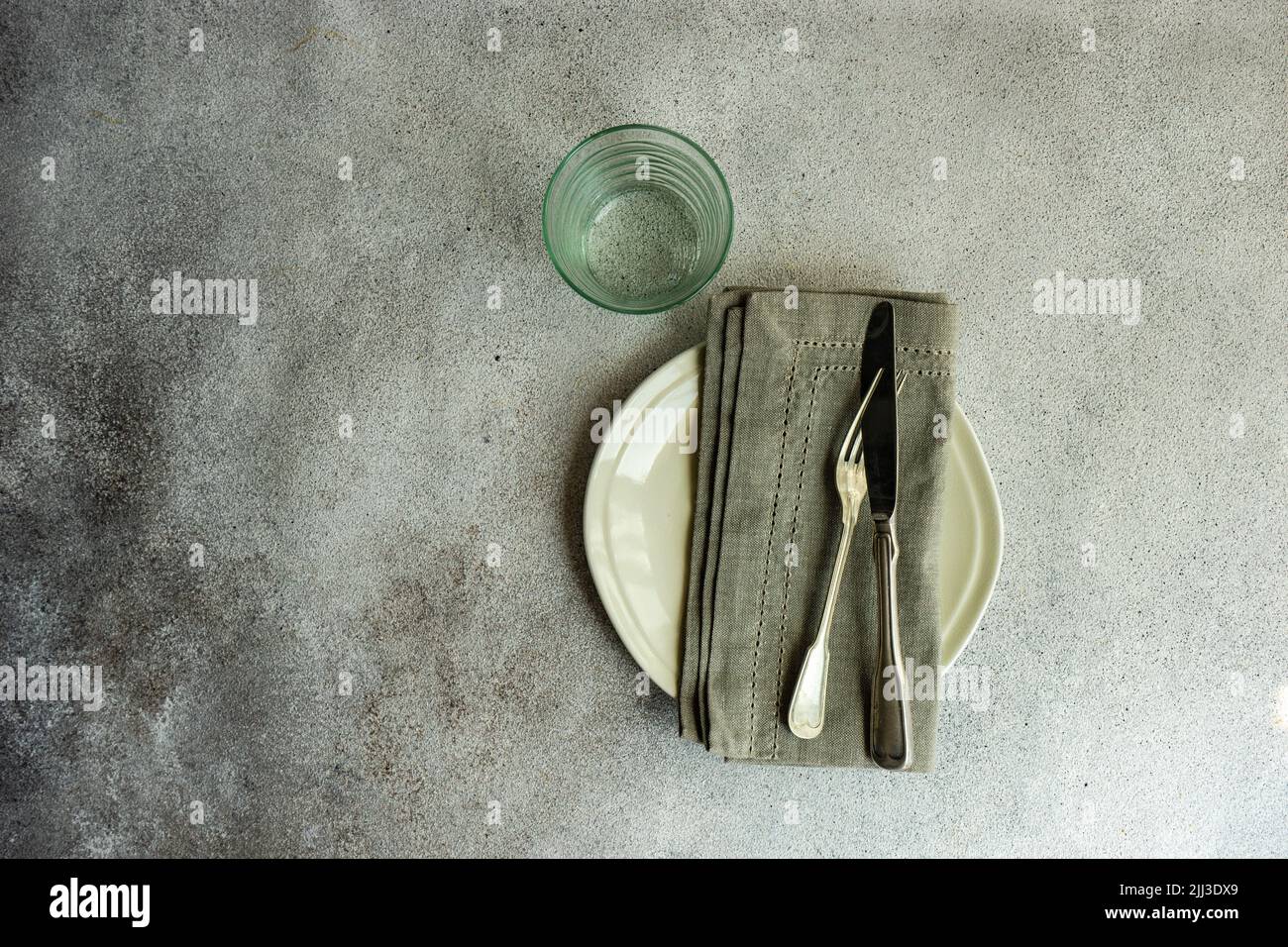 Overhead table setting in minimalistic style on concrete background ...