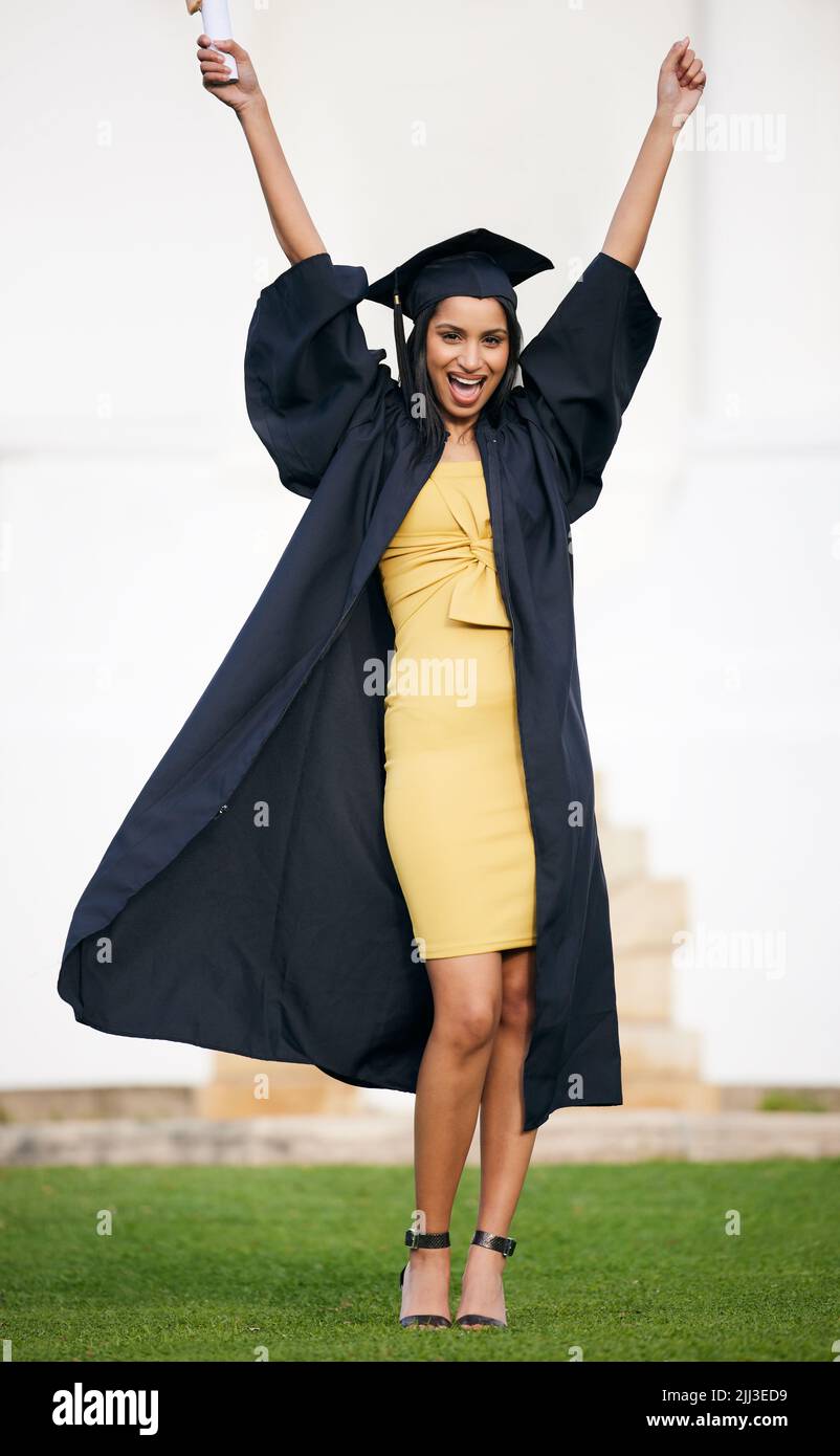 Its a bright and beautiful day. Portrait of a young woman cheering on ...