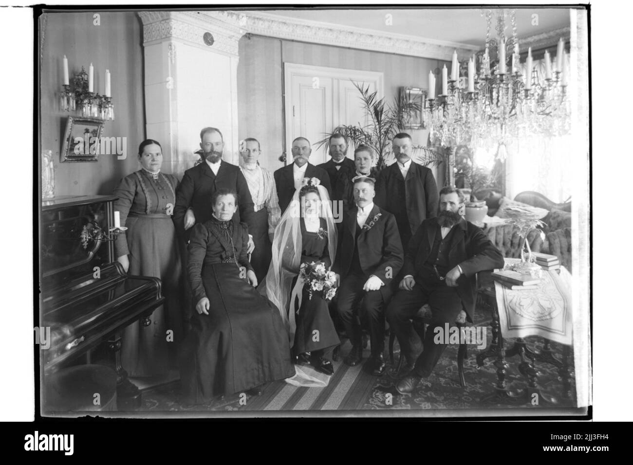 Wedding. The bride in black dress, white veil. The groom in the frack ...