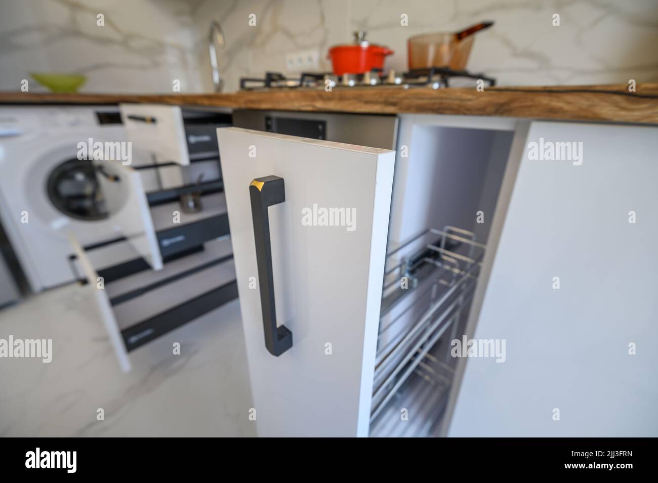 White and wooden modern kitchen furniture, some drawers open Stock ...