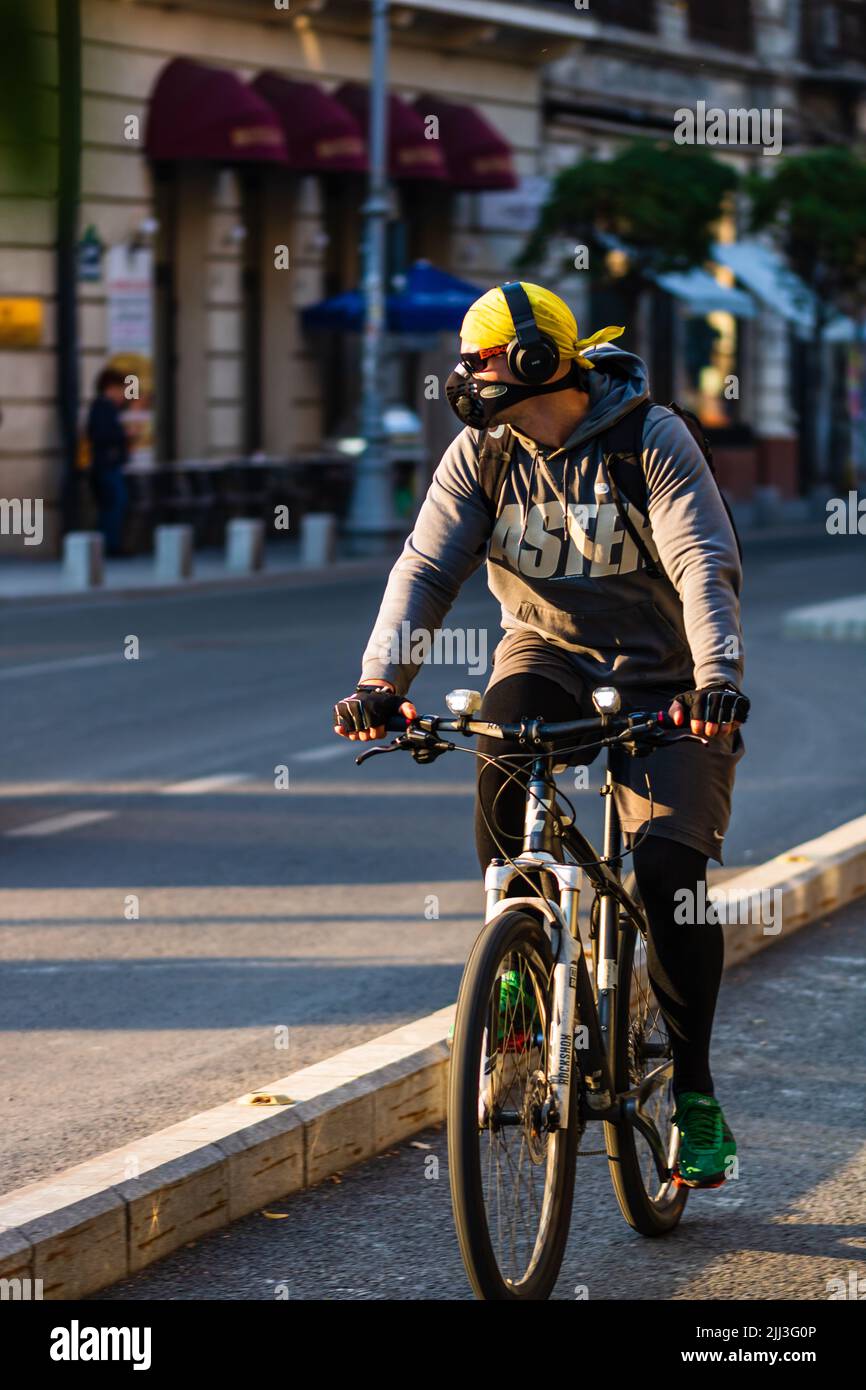 Riding a bicycle on the city streets. Commute to work in Bucharest ...
