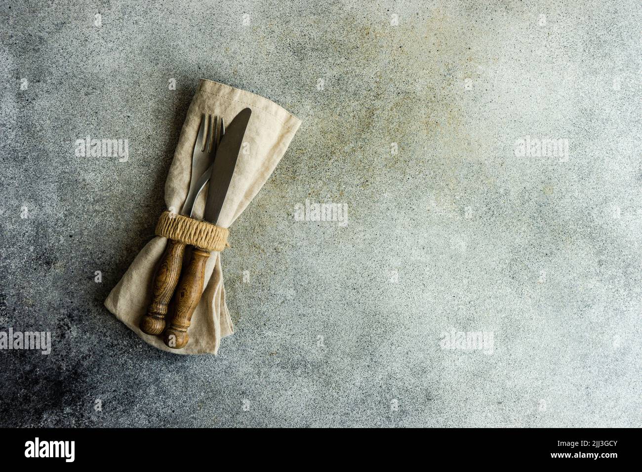 Cutlery set with textile napkin and silverware on concrete table Stock ...