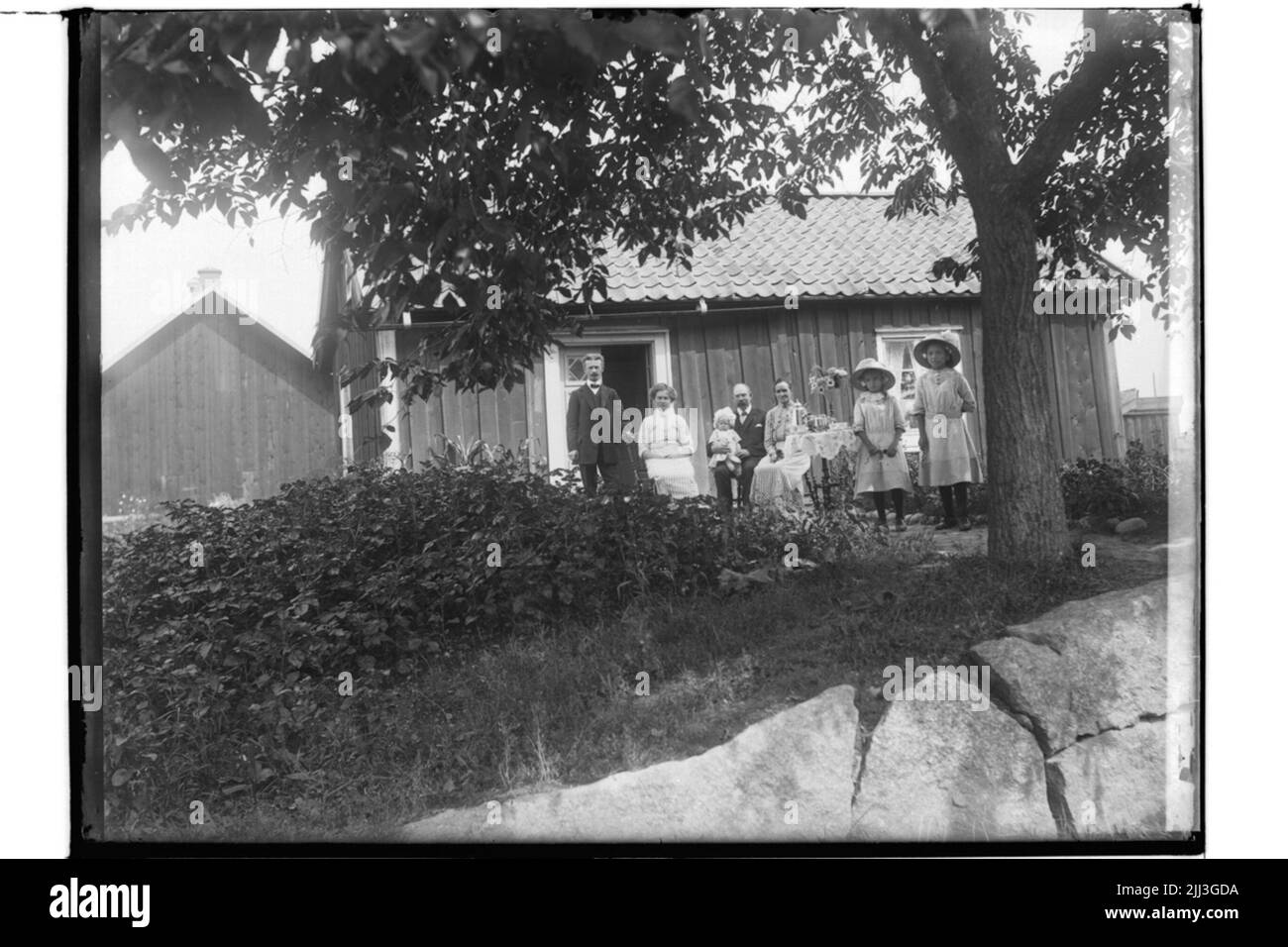 One -storey single cottage.7 people at the coffee table in front of the ...