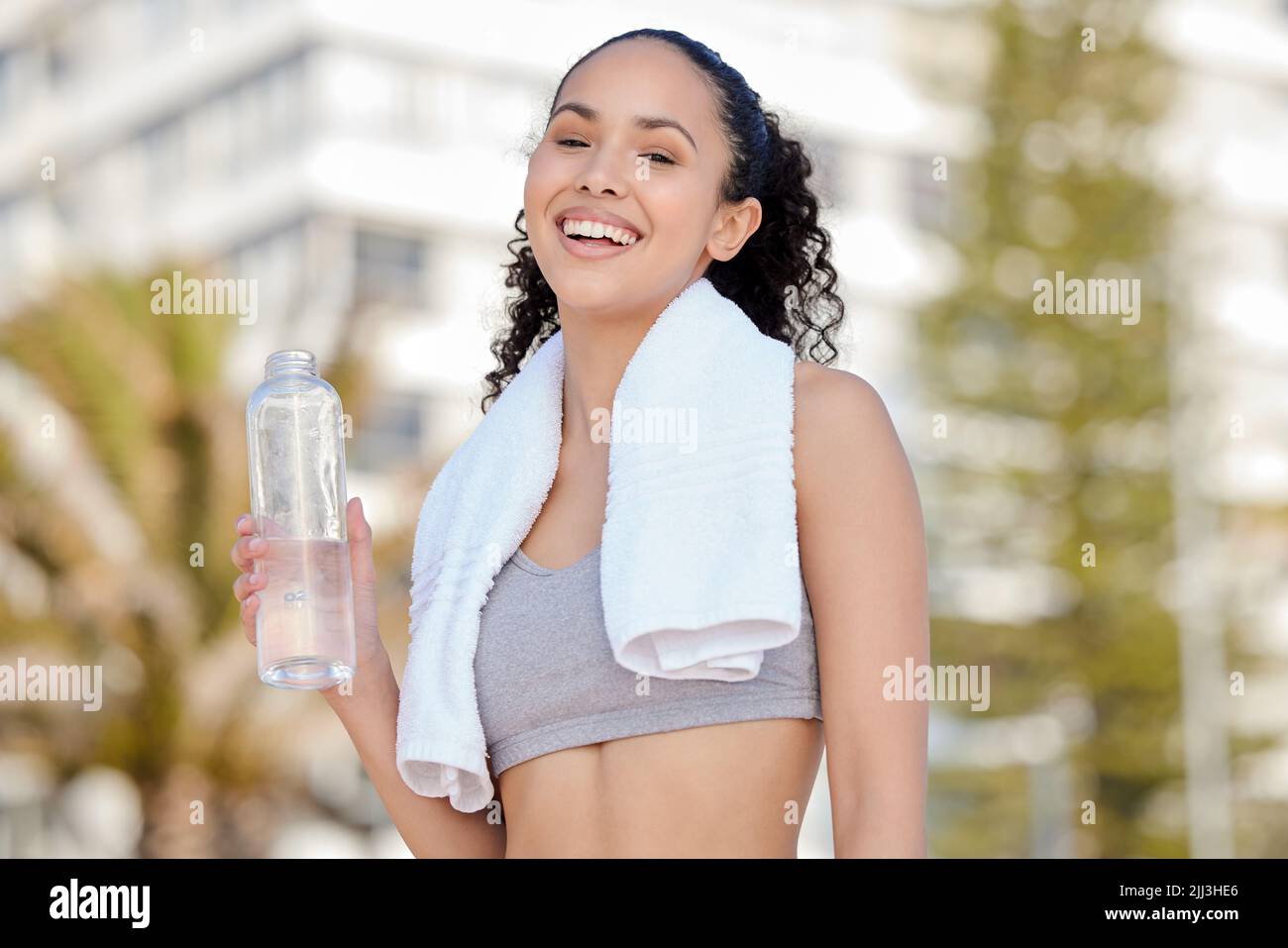 The drink that keeps on giving. a young woman drinking water during a ...