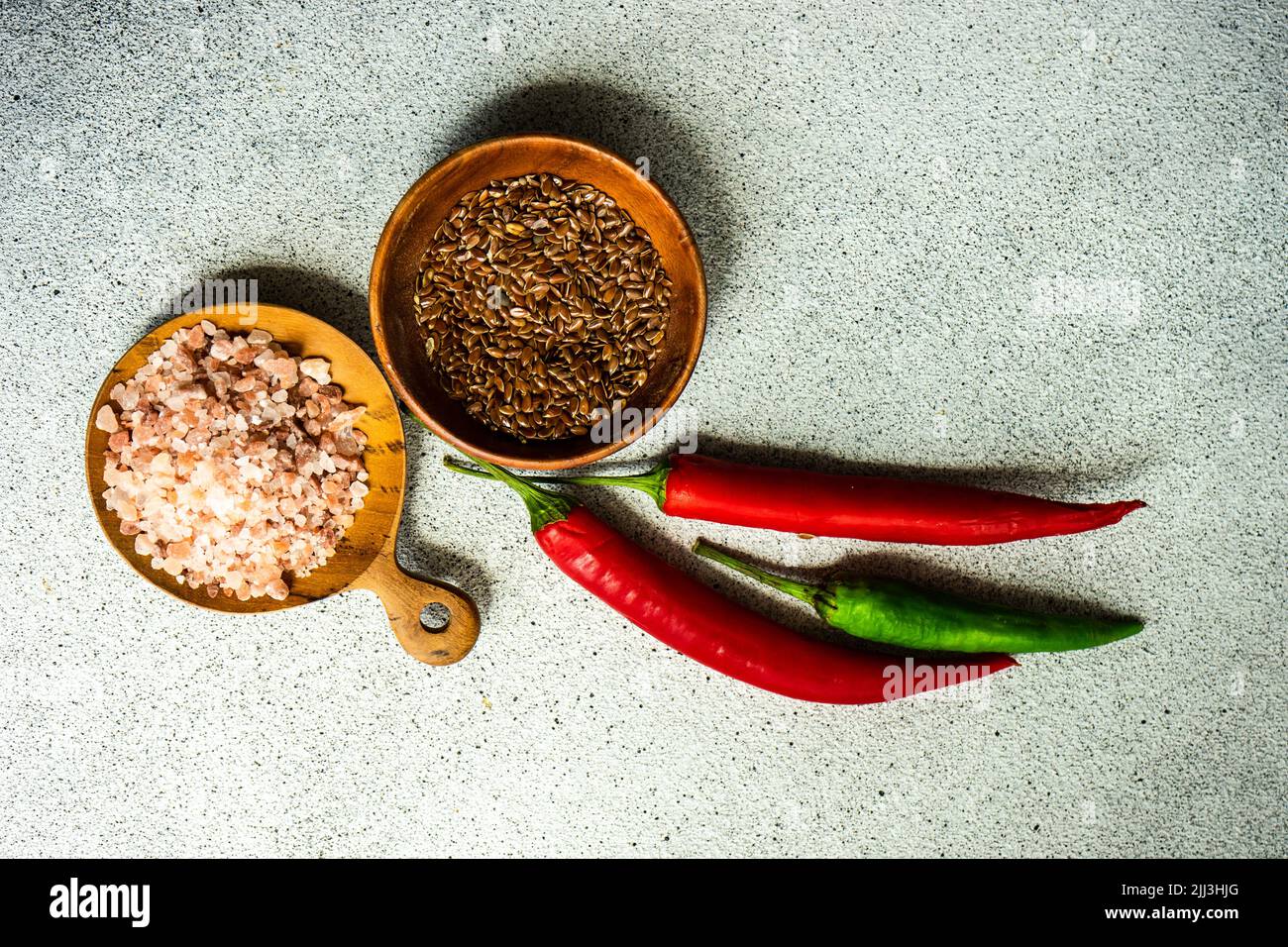 Flax seeds and pink salt in the bowls with fresh spicy chilli pepper on ...