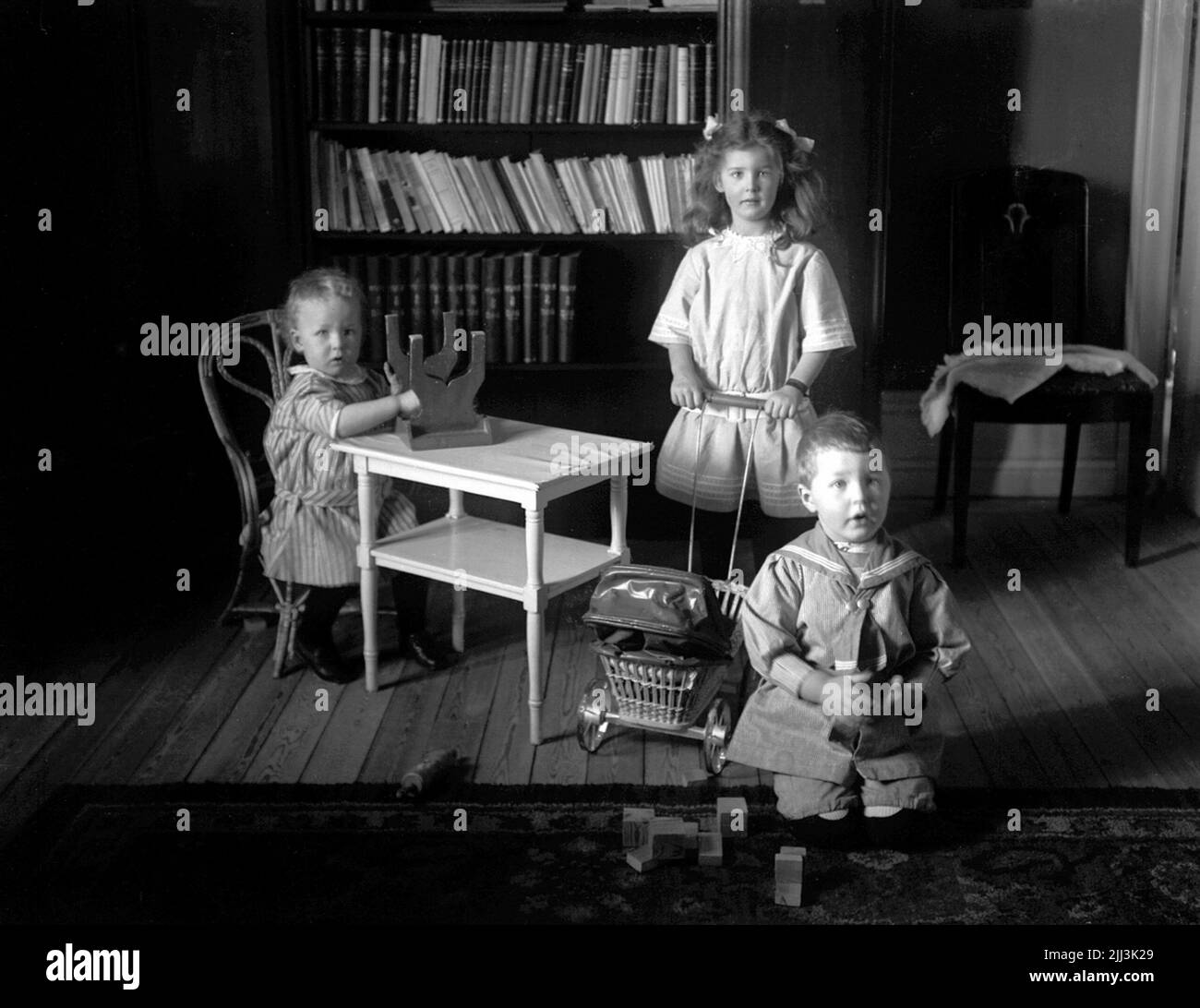 Room interior, three playful children.Maj, Carl-Edvard and Sven ...