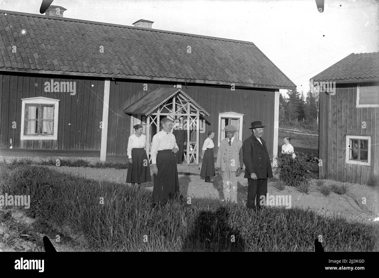 Residential building, family group seven people in front of the house ...
