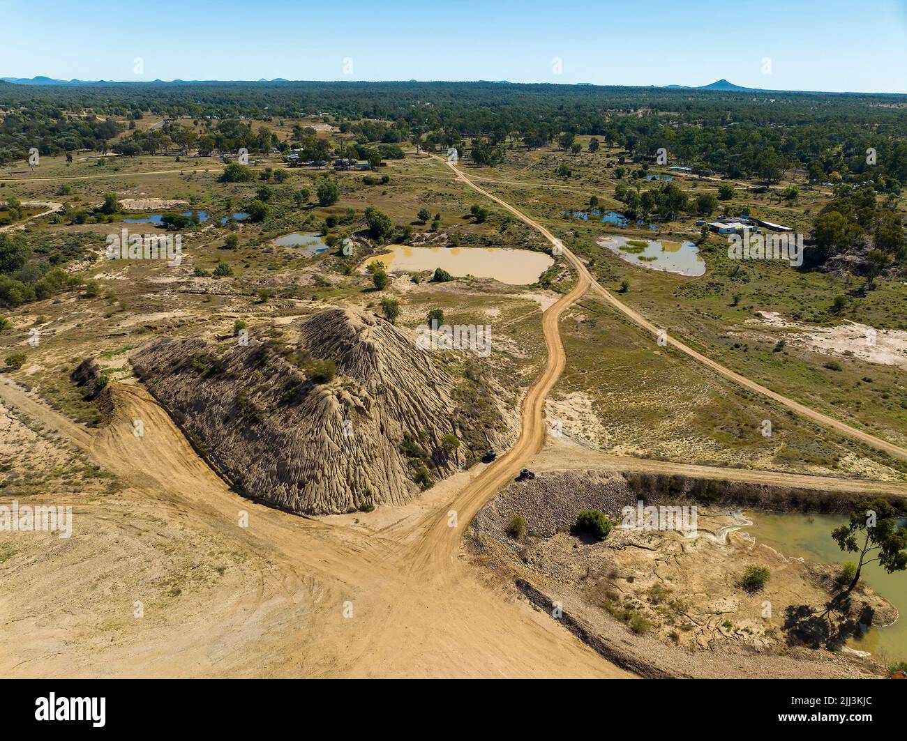 A huge mound of dirt piled after miners dig for sapphires on the ...