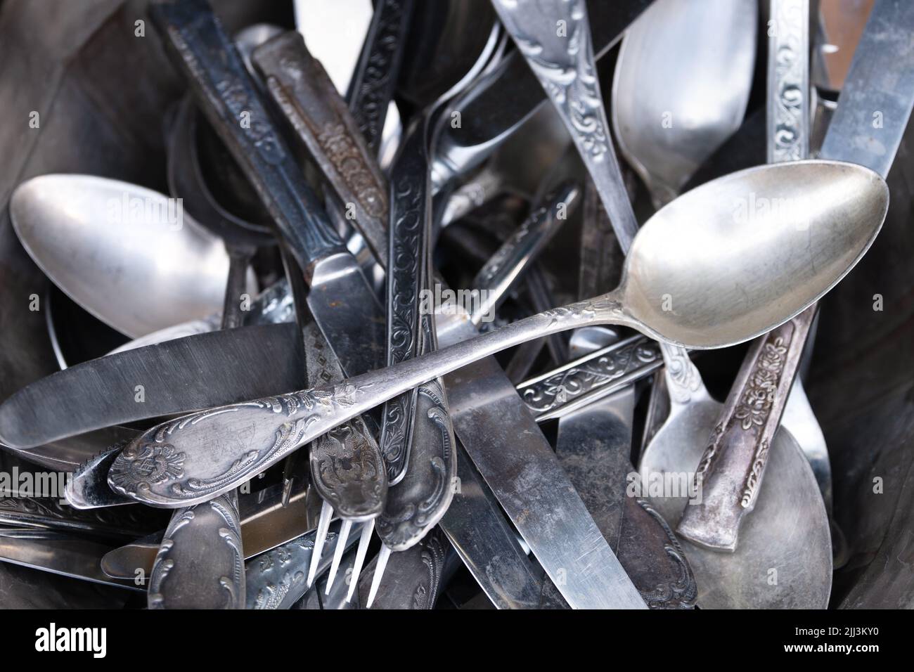 Pile of old silver forks,spoons and knifes in a silver bowl Stock Photo ...