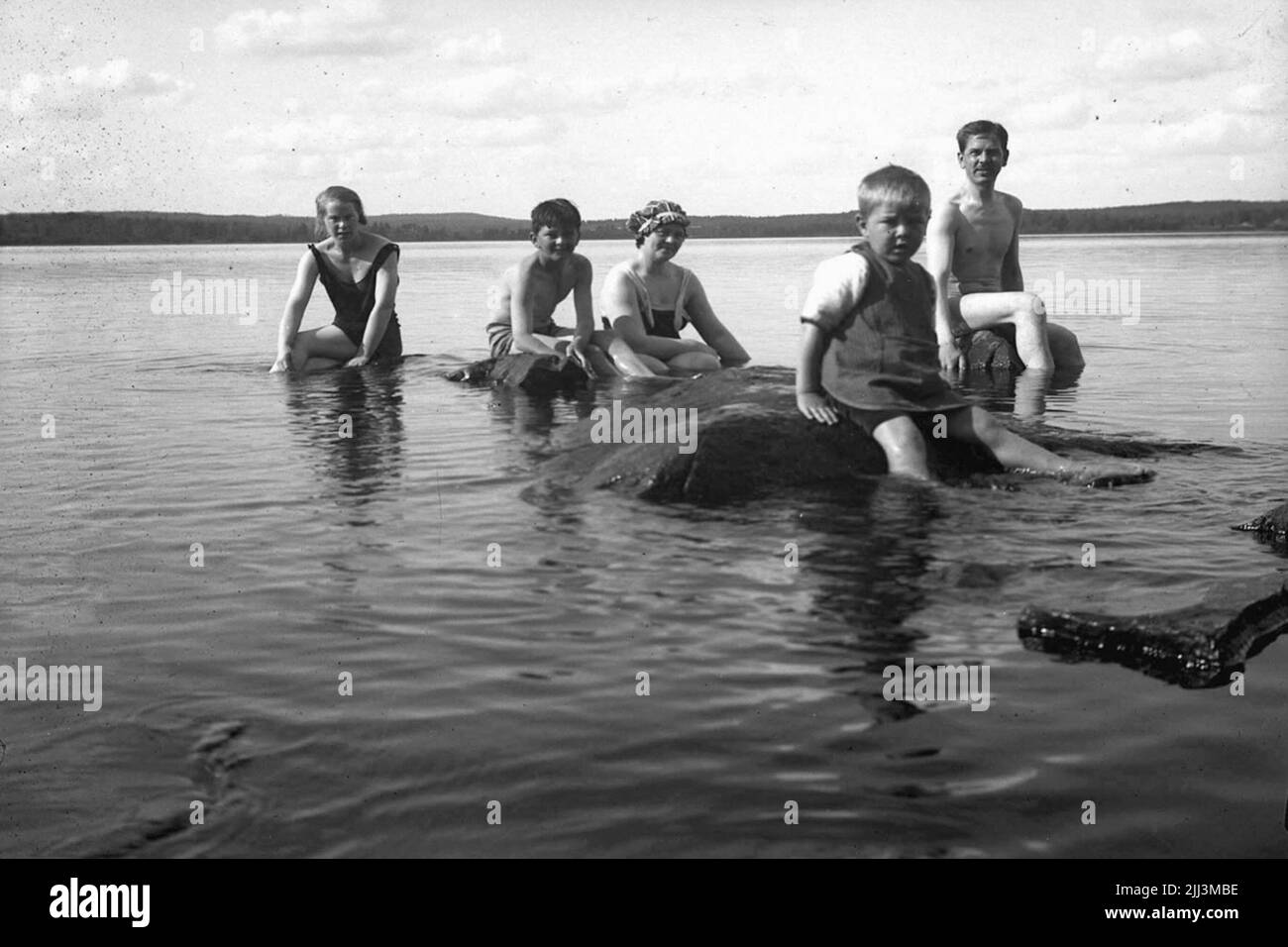 Three children and two adults bathe in lake Stock Photo - Alamy