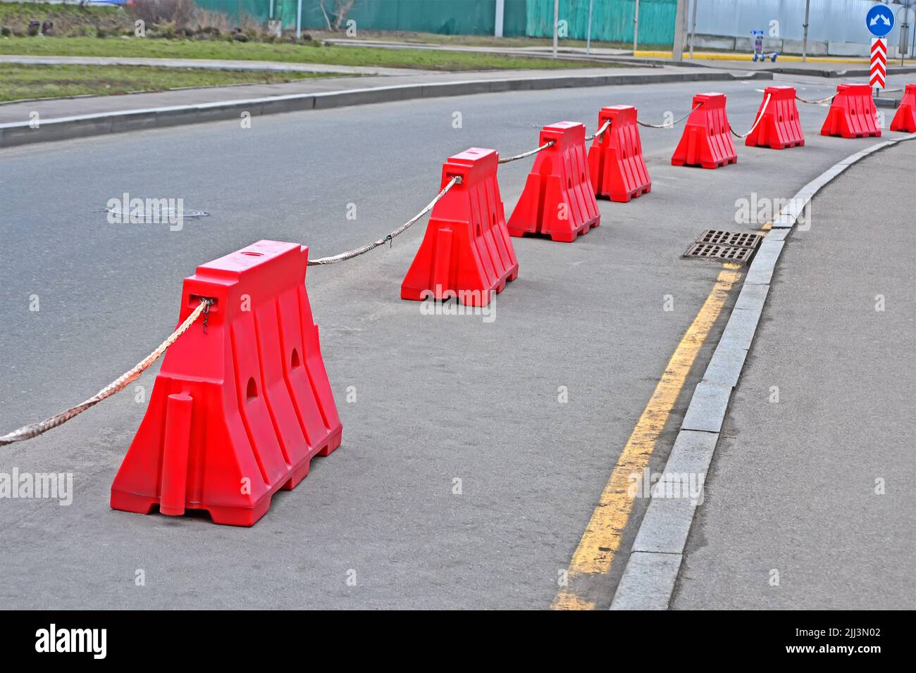 red plastic pylon barrier line on the street, modern security diversity ...