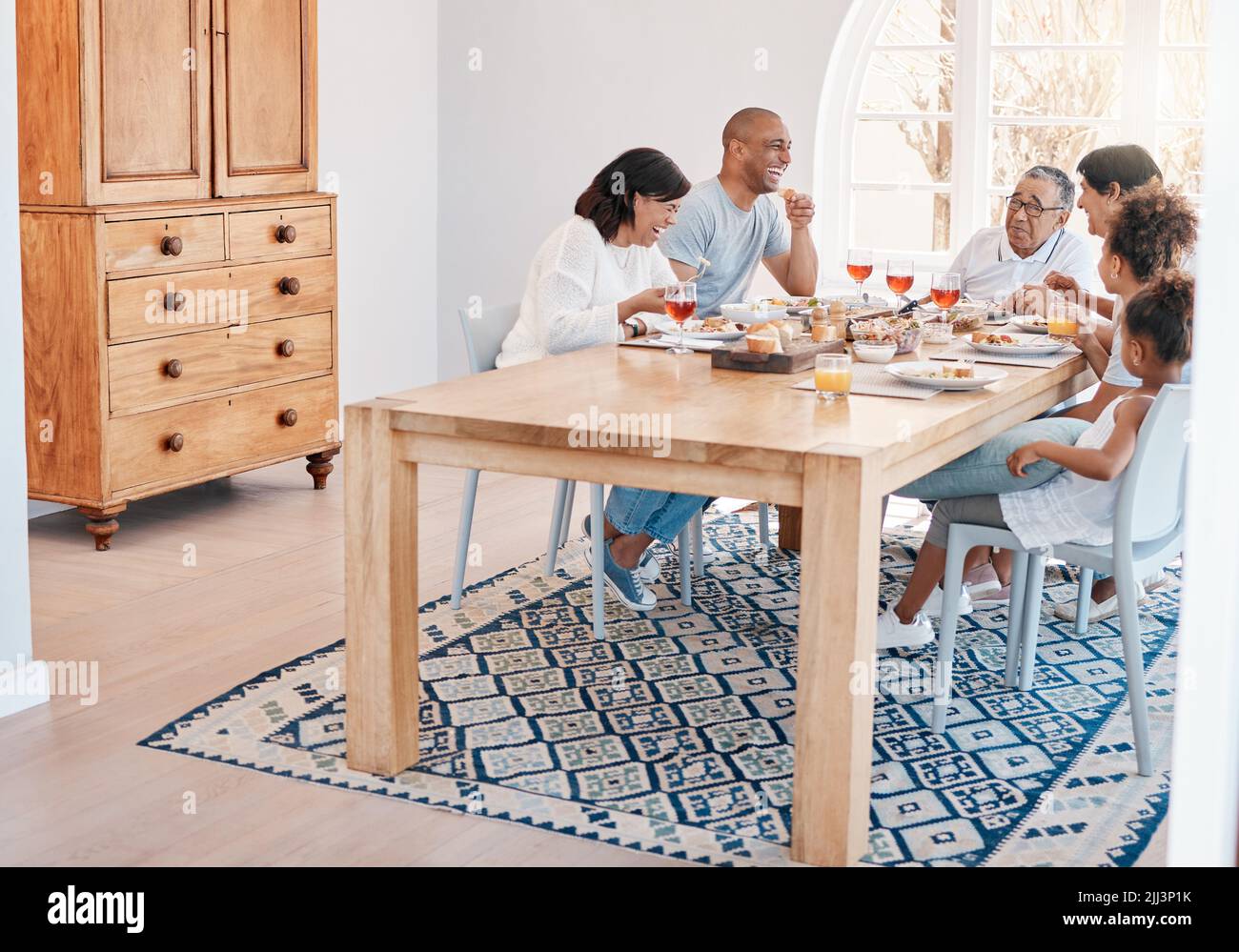 Deep belly laughs are so important. a family having lunch together ...