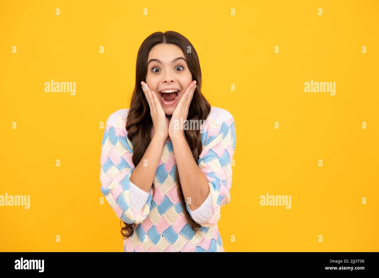 Shocked teenager child with amazed look on yellow background, amazement ...