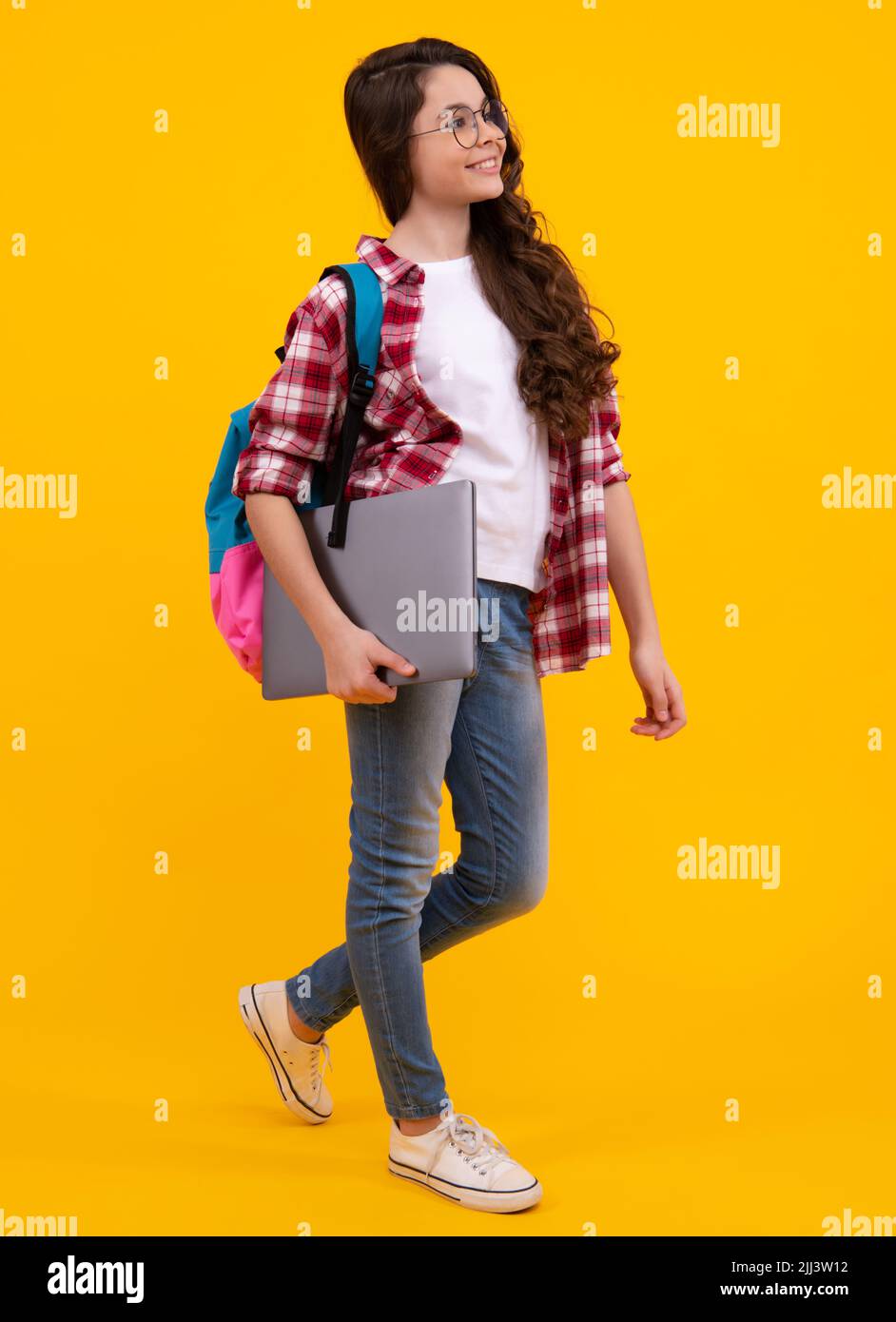 Schoolgirl in school uniform with laptop. Schoolchild, teen student on ...
