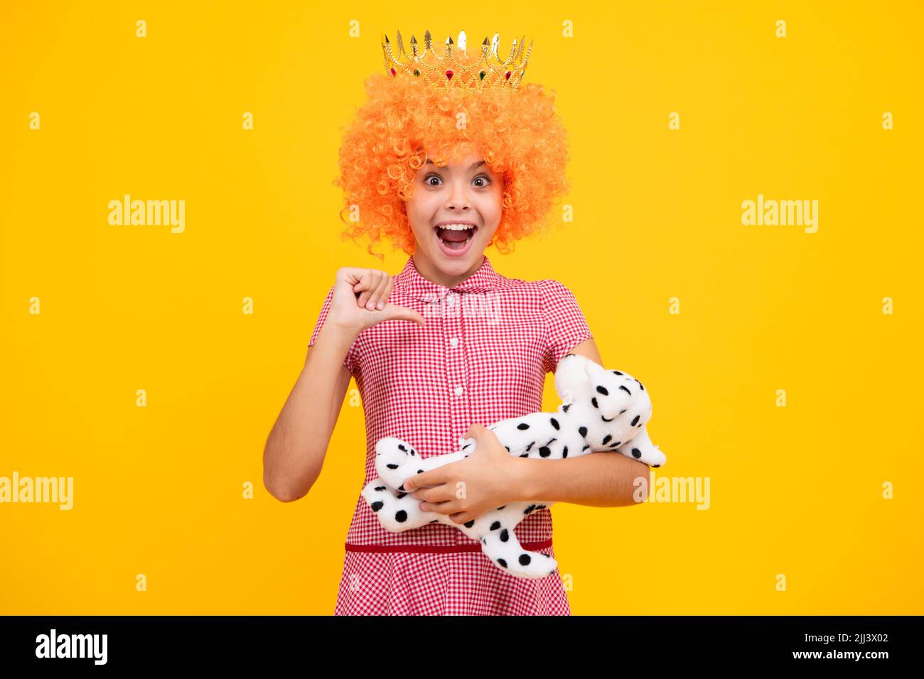 Amazed teen girl in fancy clown wig. Teenager princess child celebrates ...