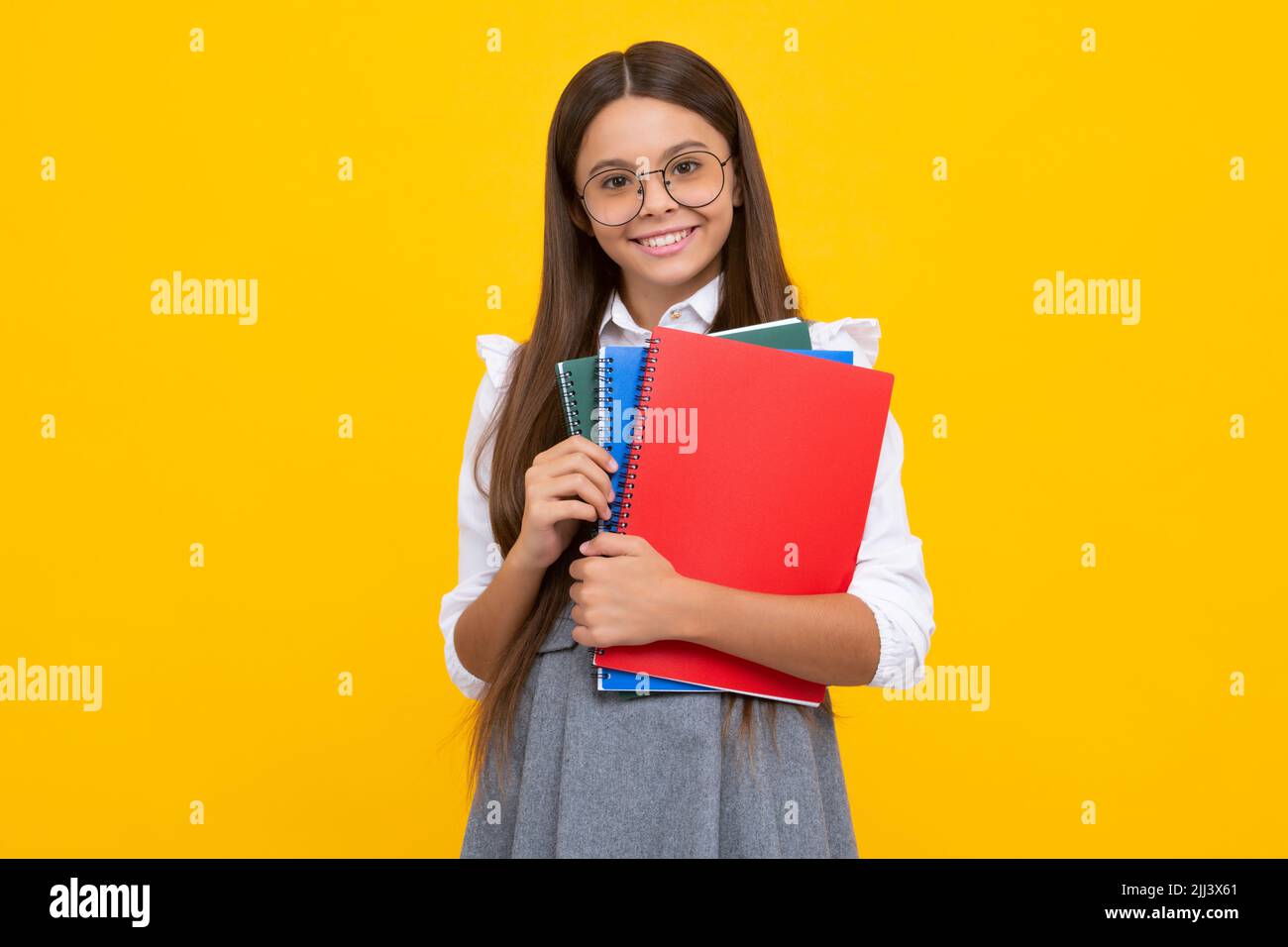 Schoolgirl with copy book posing on isolated background. Literature ...