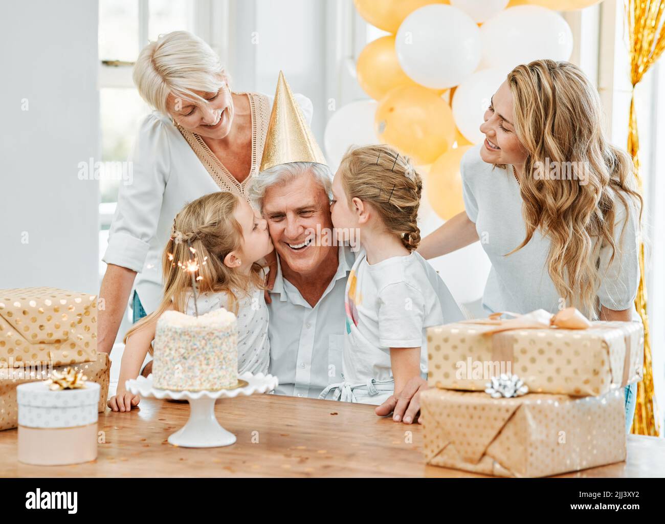 Kisses are better than presents. a happy family celebrating a birthday ...