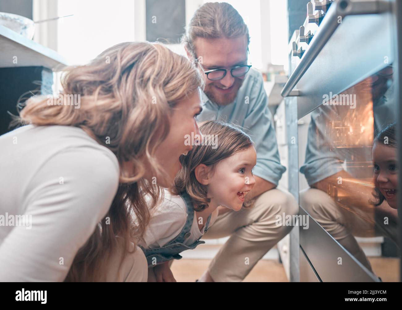 The smell of good bread baking. a little girl and her parents sitting ...
