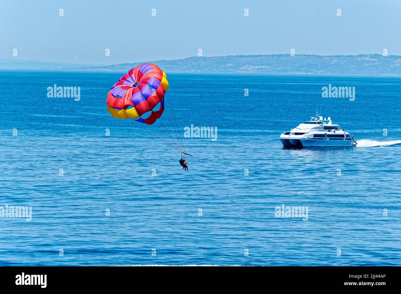 Yacht Approaching Parasailor Stock Photo - Alamy