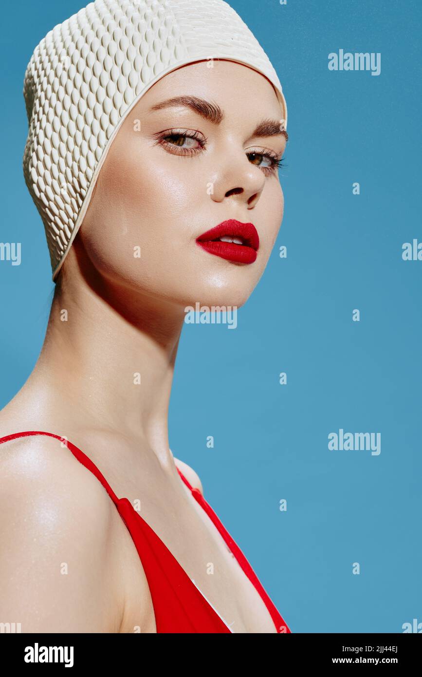 Conceptual swimmer in a red swimsuit on a blue background Stock Photo ...