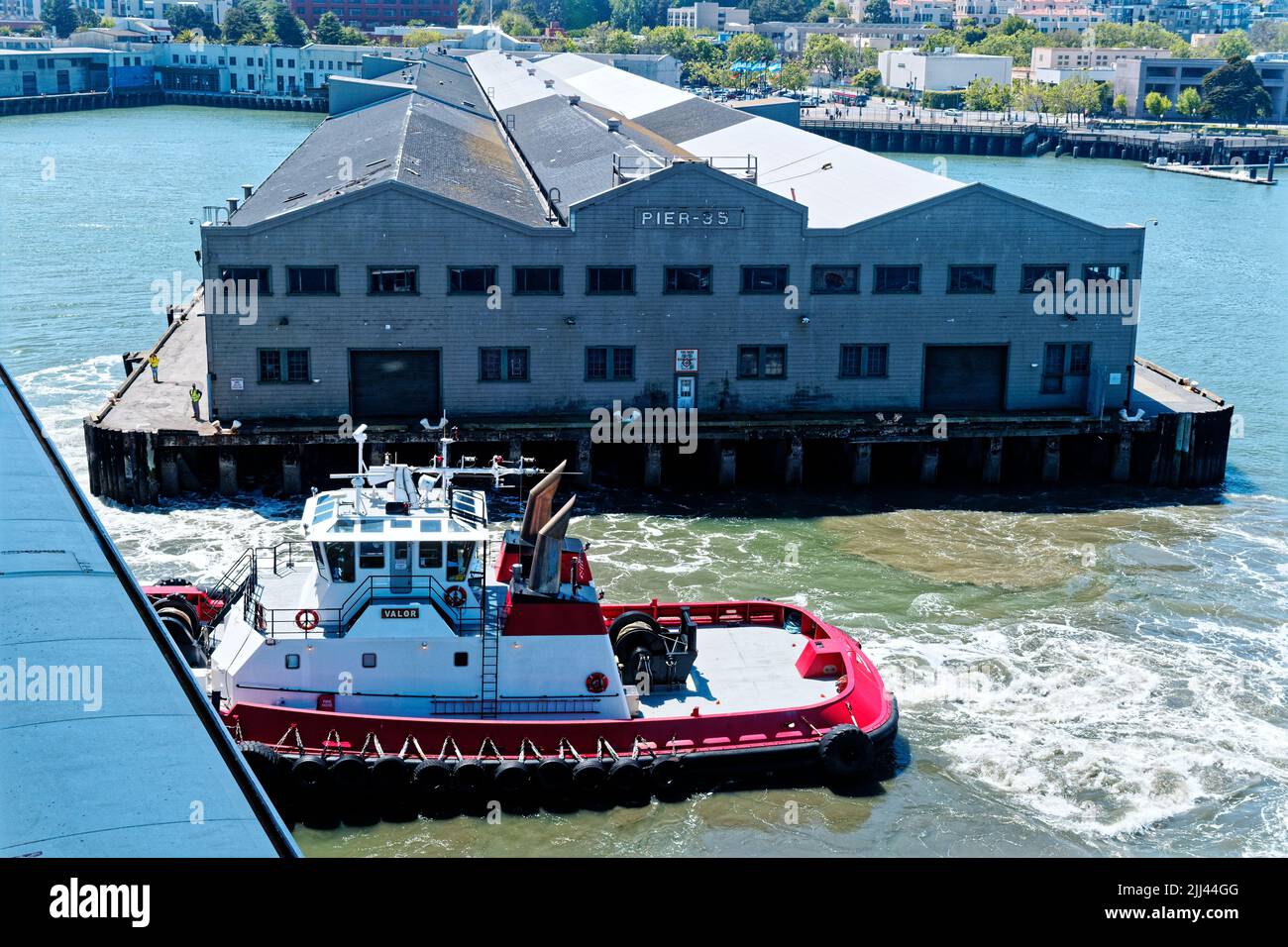 Tugboat Pushing Cruise Ship into San Francisco Pier Stock Photo - Alamy