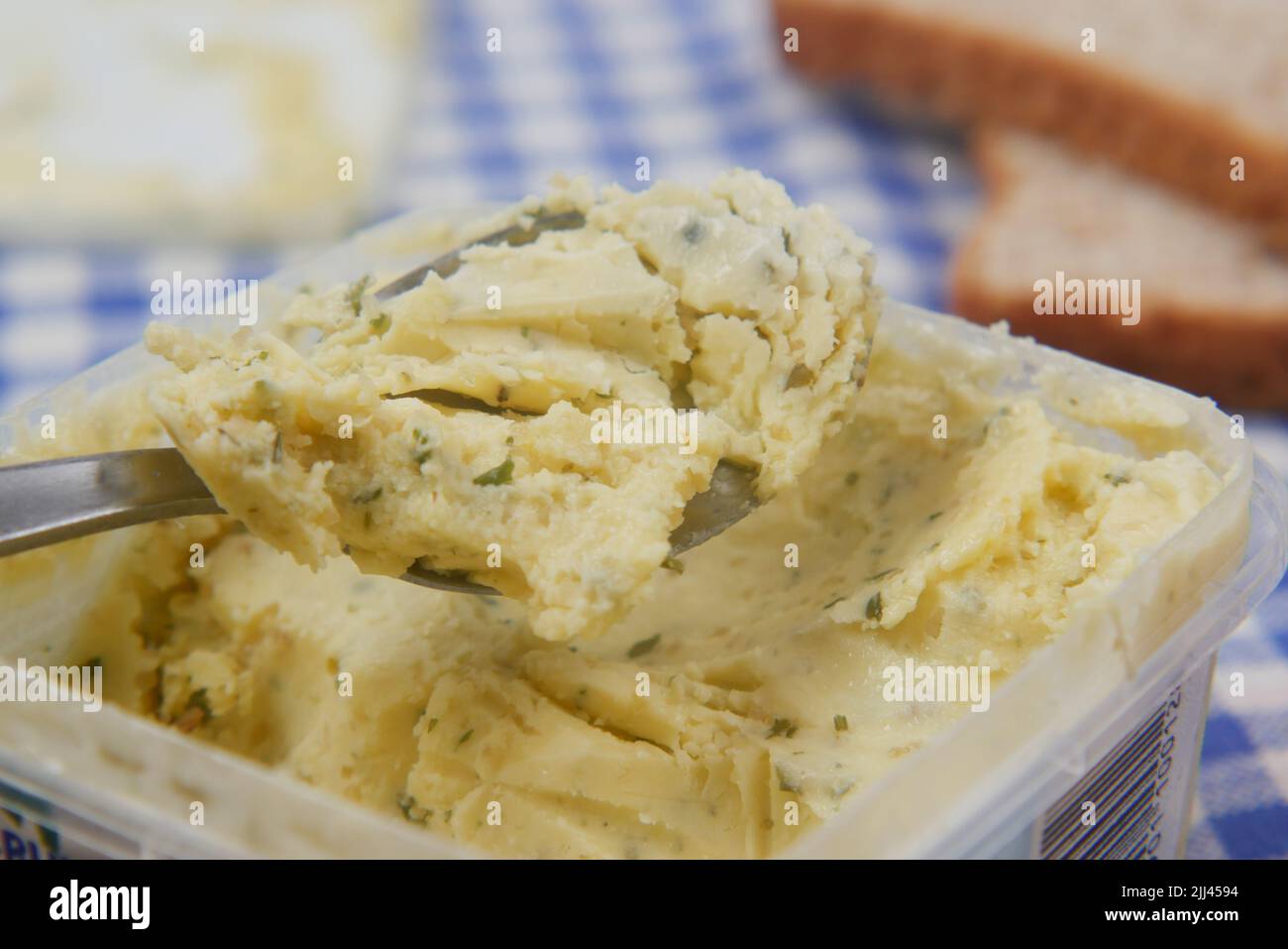 fresh garlic butter in a container on white background Stock Photo - Alamy