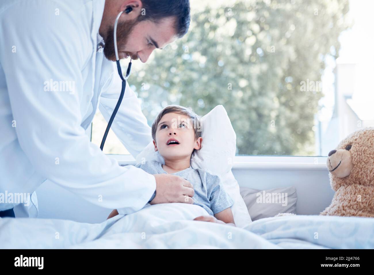 Youve got the healthiest heart. a male doctor doing a checkup on a sick ...