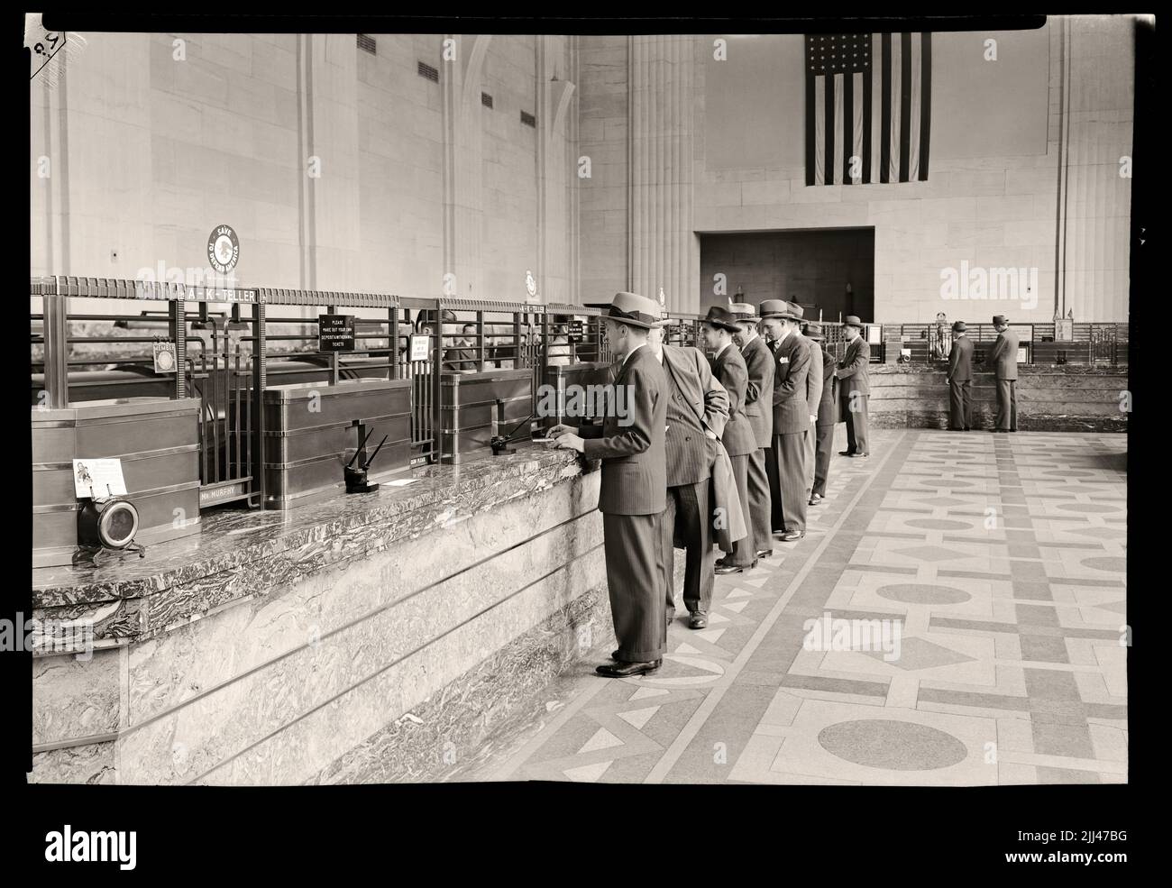 Customers in bank lobby, step up to the teller’s window. New York ...