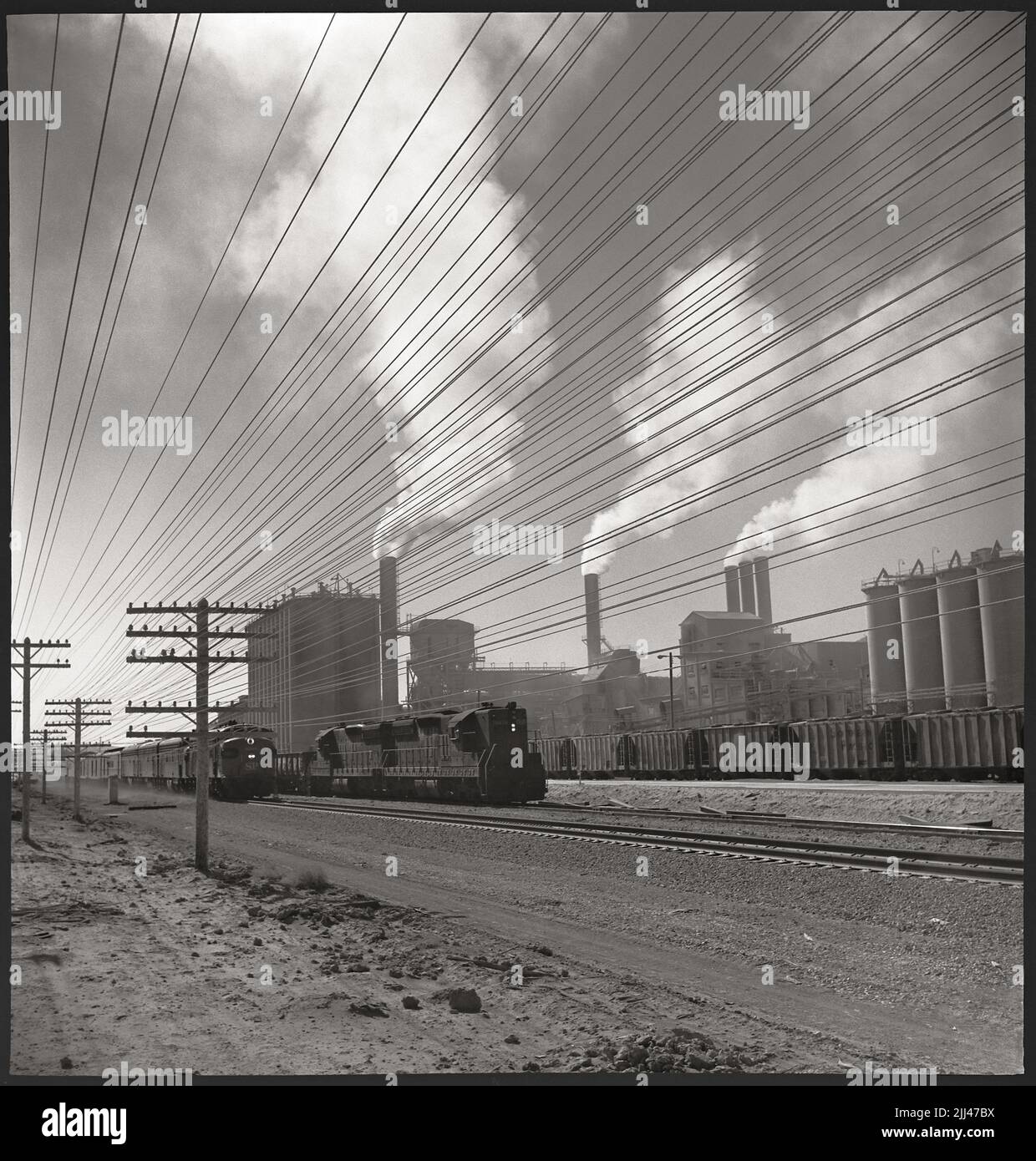 Cement Plant, rail lines and power lines in Monolith CA. 1962. Image ...