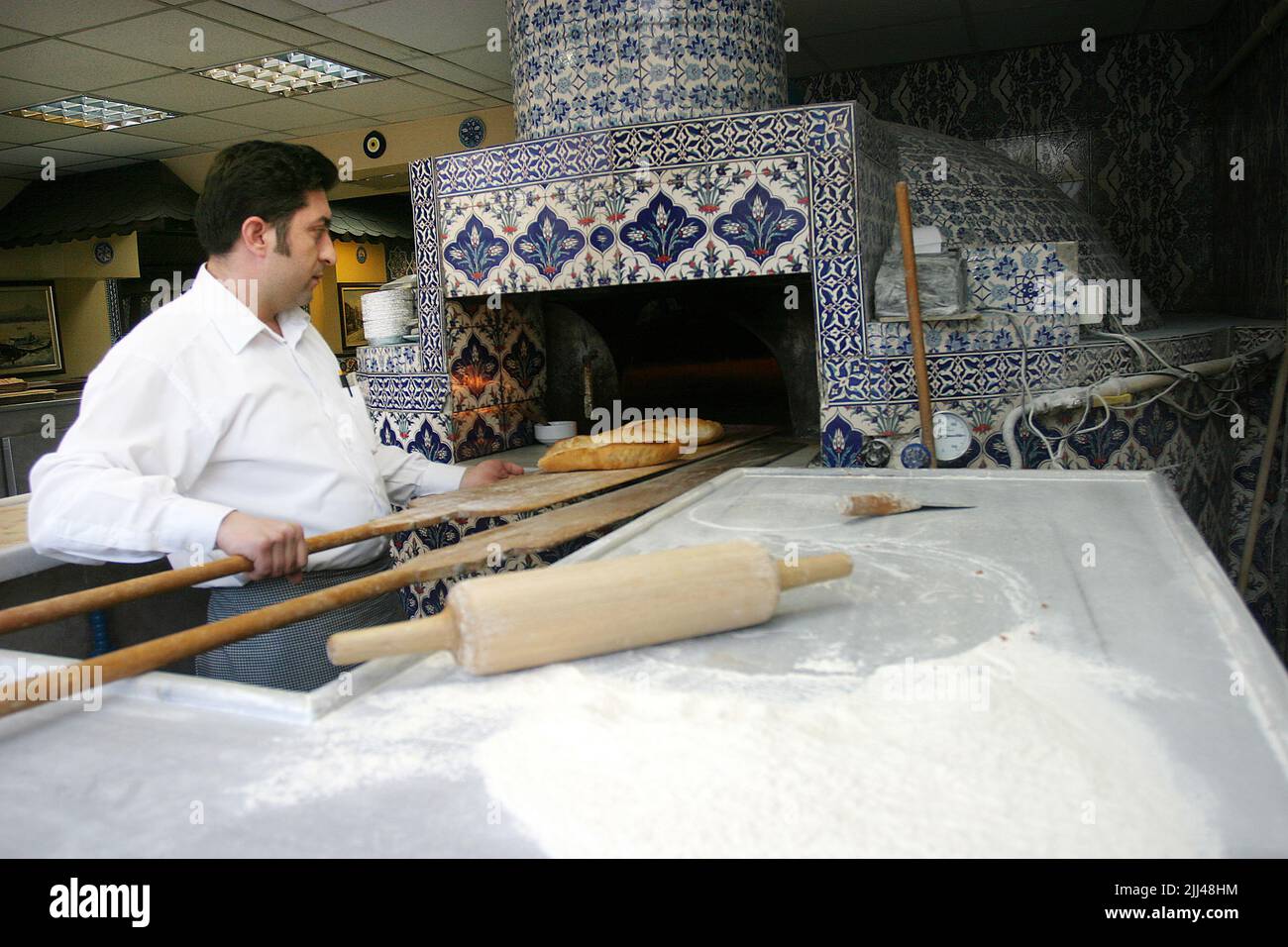 ISTANBUL, TURKEY - MAY 14: A baker making Turkish bread on May 14, 2016 ...