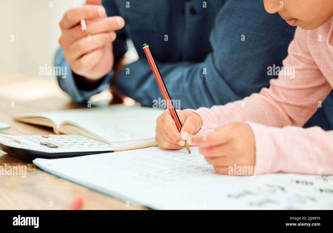 Time to do some homework. an unrecognizable little girl doing her ...