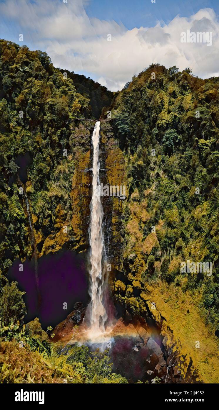 Akaka Falls State Park, waterfall in Hawaii. With blue skies and a ...