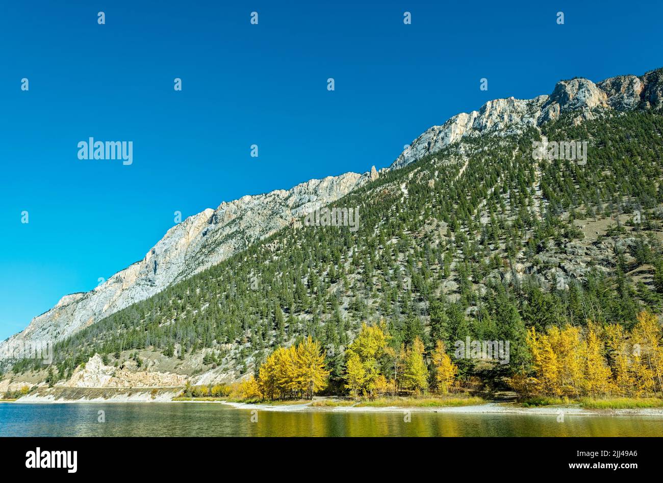 Mountains tower above the shoreline of Crown Lake at Marble Canyon ...