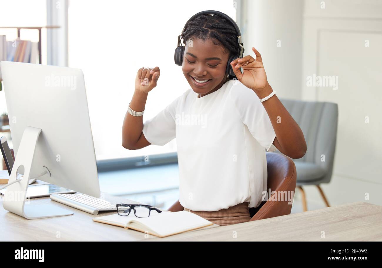 Take time for yourself too. a young businesswoman listening to music at ...