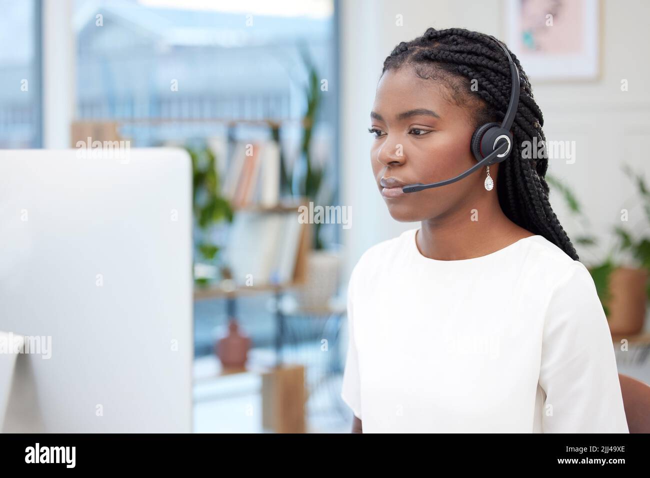 Helping people is what I do. a call centre agent sitting behind her ...