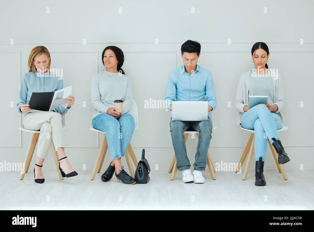 Time to prepare. a group of businesspeople waiting in line at an office ...