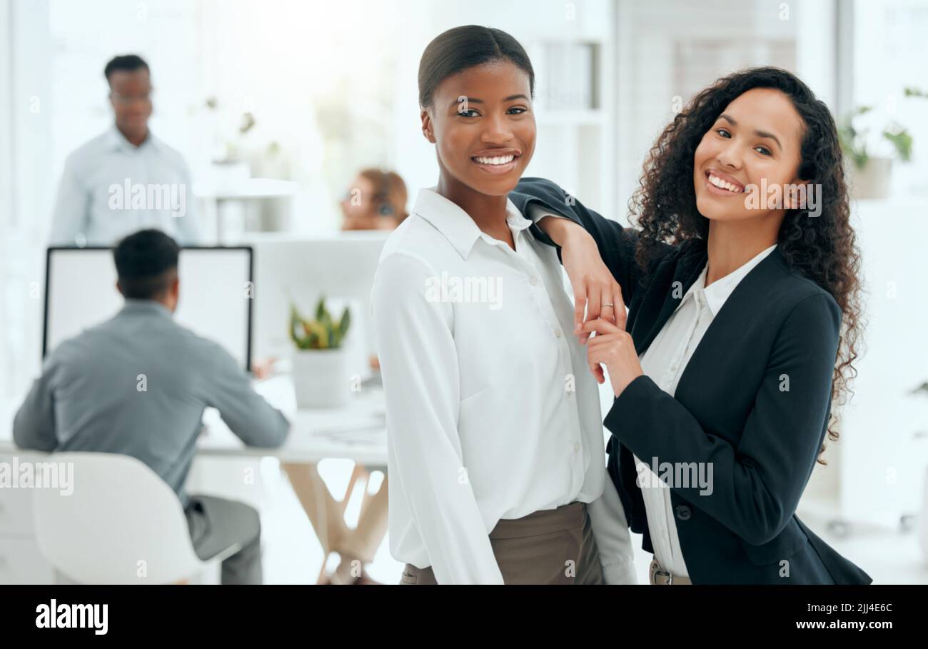 We own the corporate world. Cropped portrait of two attractive young businesswomen standing in ...