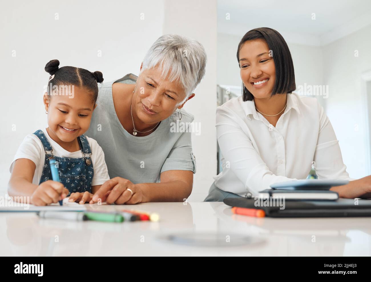 Thats a beautiful flower. a young girl getting help from her mother and ...