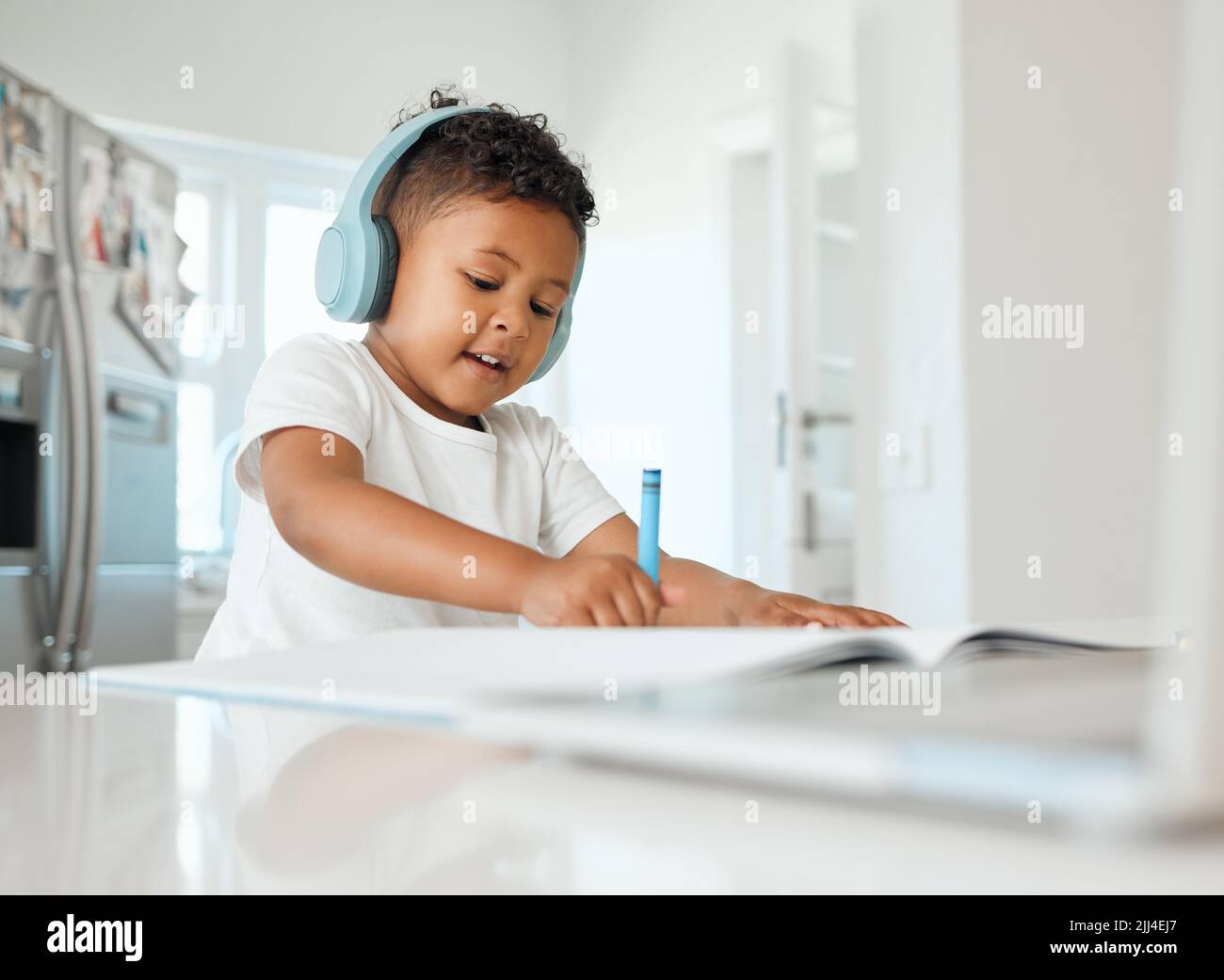 Stay in the lines. a little boy doing his homework at home Stock Photo ...