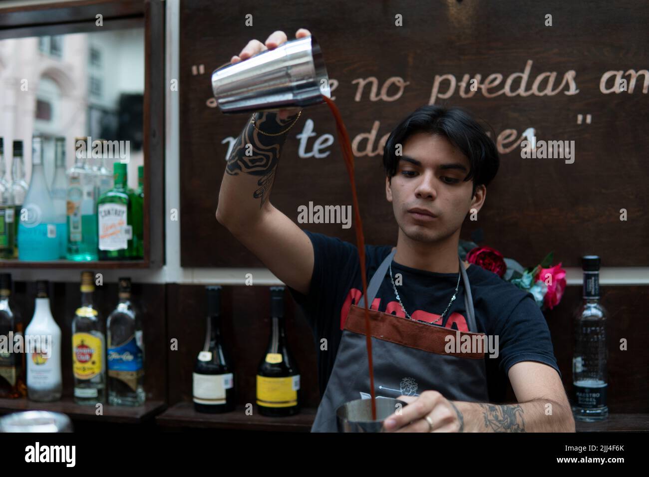 Latin bartender mixing a drink in an impressive way. Cocktail skills of ...