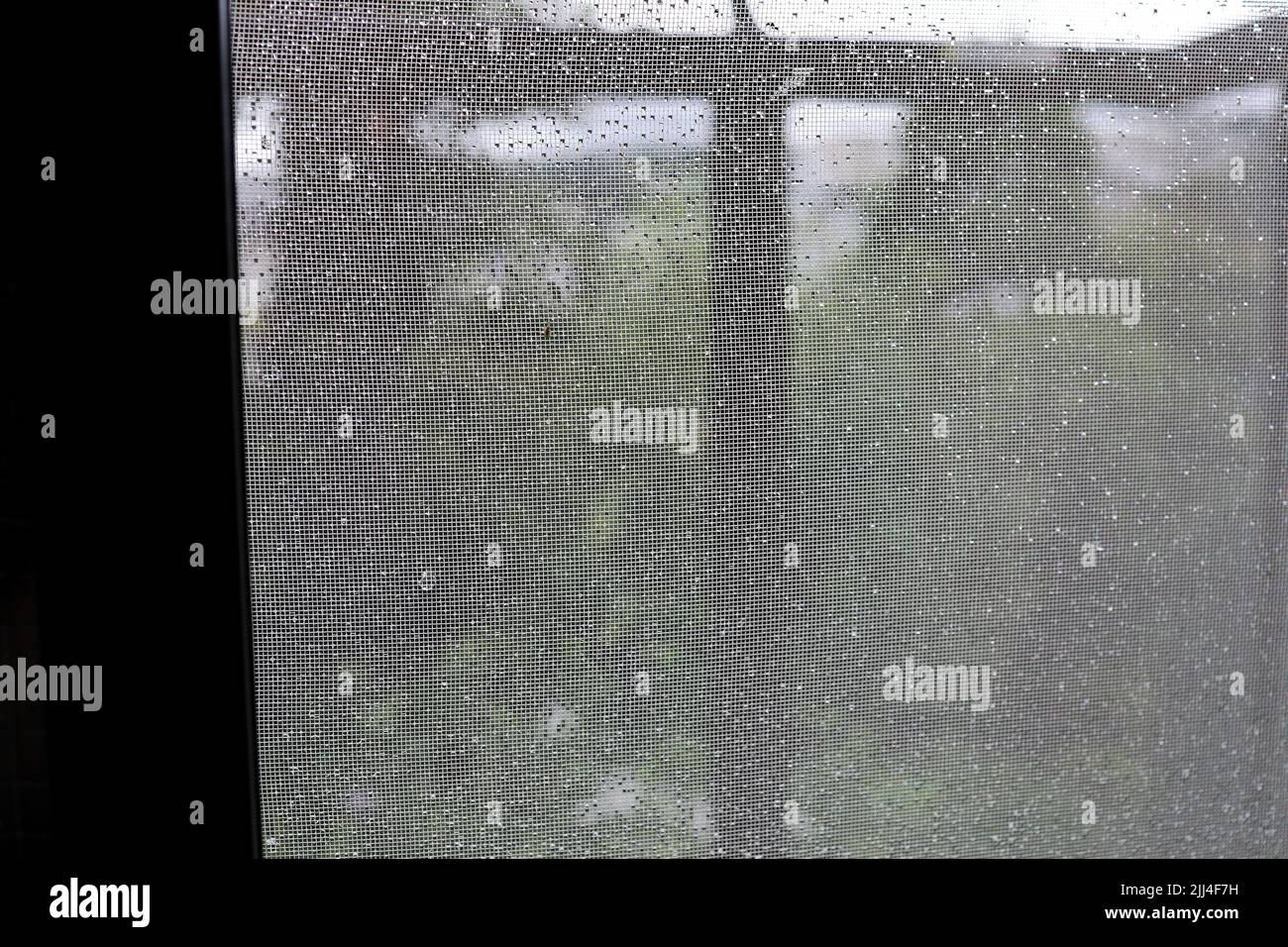 Water droplets on the screen door after the rain and the scenery ...