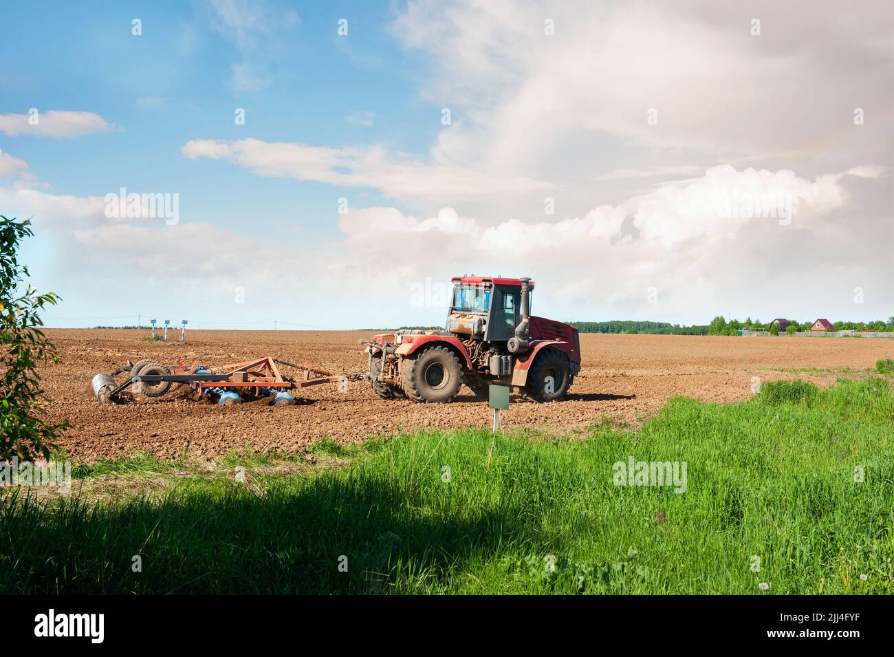 The tractor plows the land. Preparation for sowing and planting ...