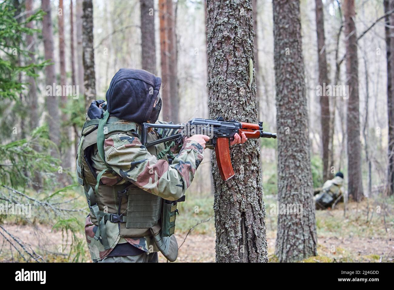 a human in the forest shoots from a machine gun Stock Photo - Alamy