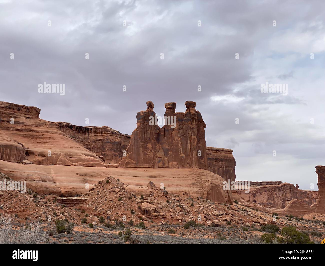 Photo of Three Gossips sandstone tower atop a pedestal within ...