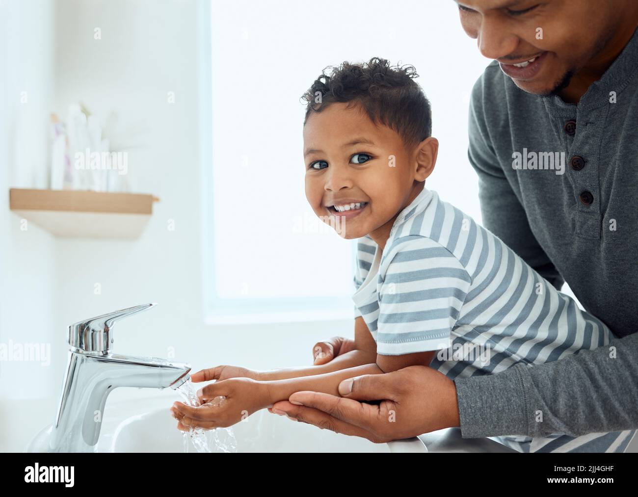 I love washing my hands with dad. an adorable little boy washing his ...