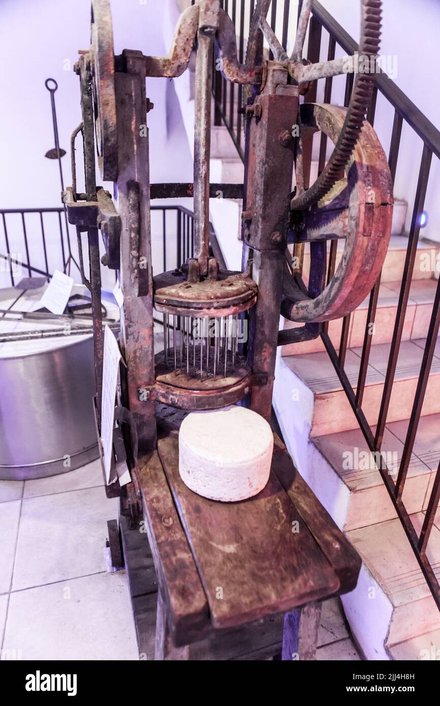 Cheese fabrication : Cheese punching machine Stock Photo - Alamy