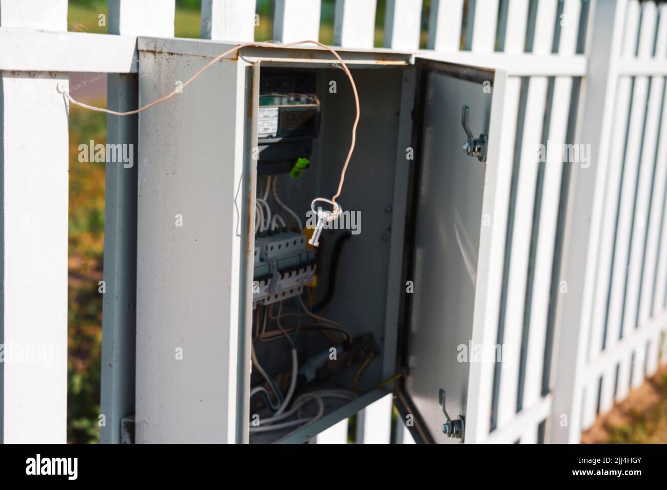inspection of an electrician meter hanging on wooden fence Stock Photo ...