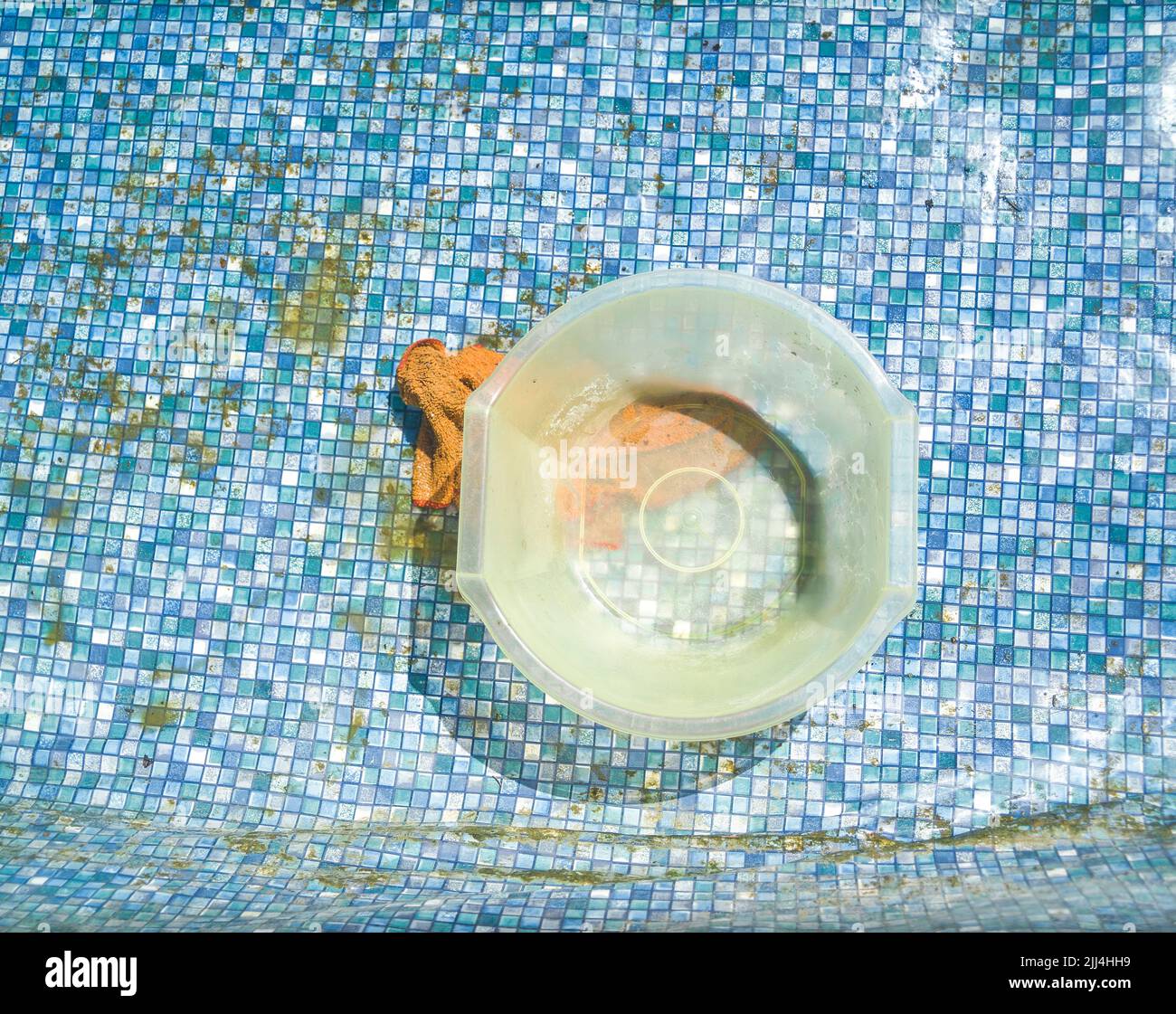 a plastic basin and cloth for cleaning outdoor pool, above shot Stock ...